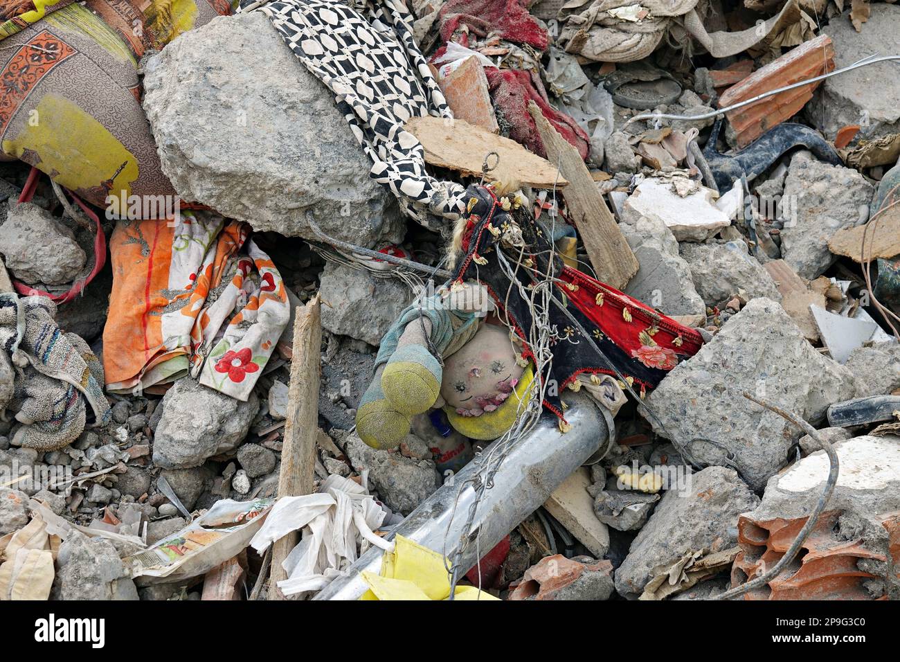 A doll is seen in the wreckage of one of the buildings destroyed in the ...