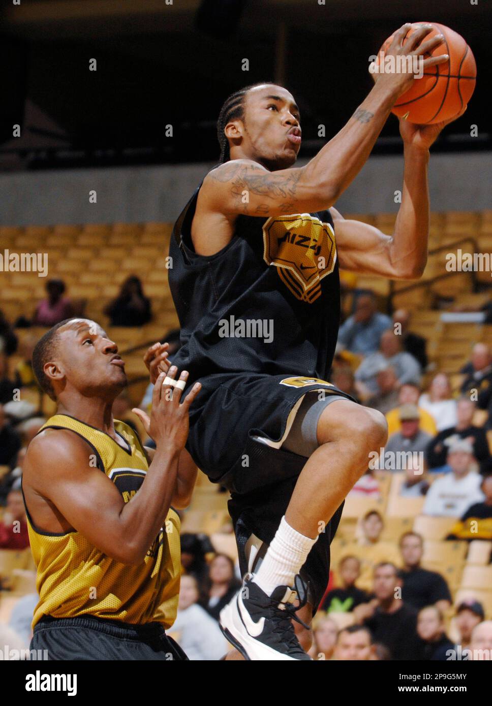 Missouri's Marcus Denmon, right, shoots in front of teammate Michael ...