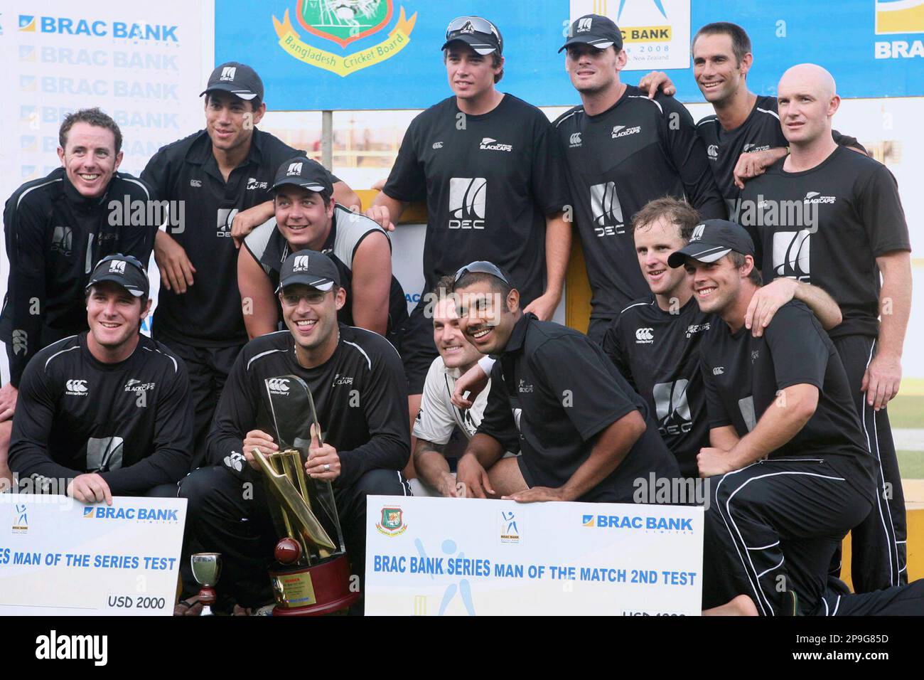 New Zealand cricketers cheer as they pose for photographs after winning ...