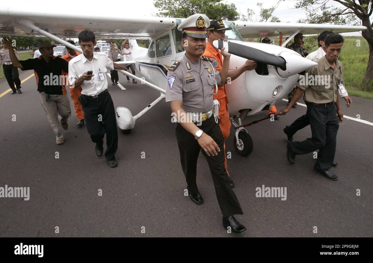 Indonesian police push a four-seater Cessna 172 PK-SDQ on the Jakarta ...