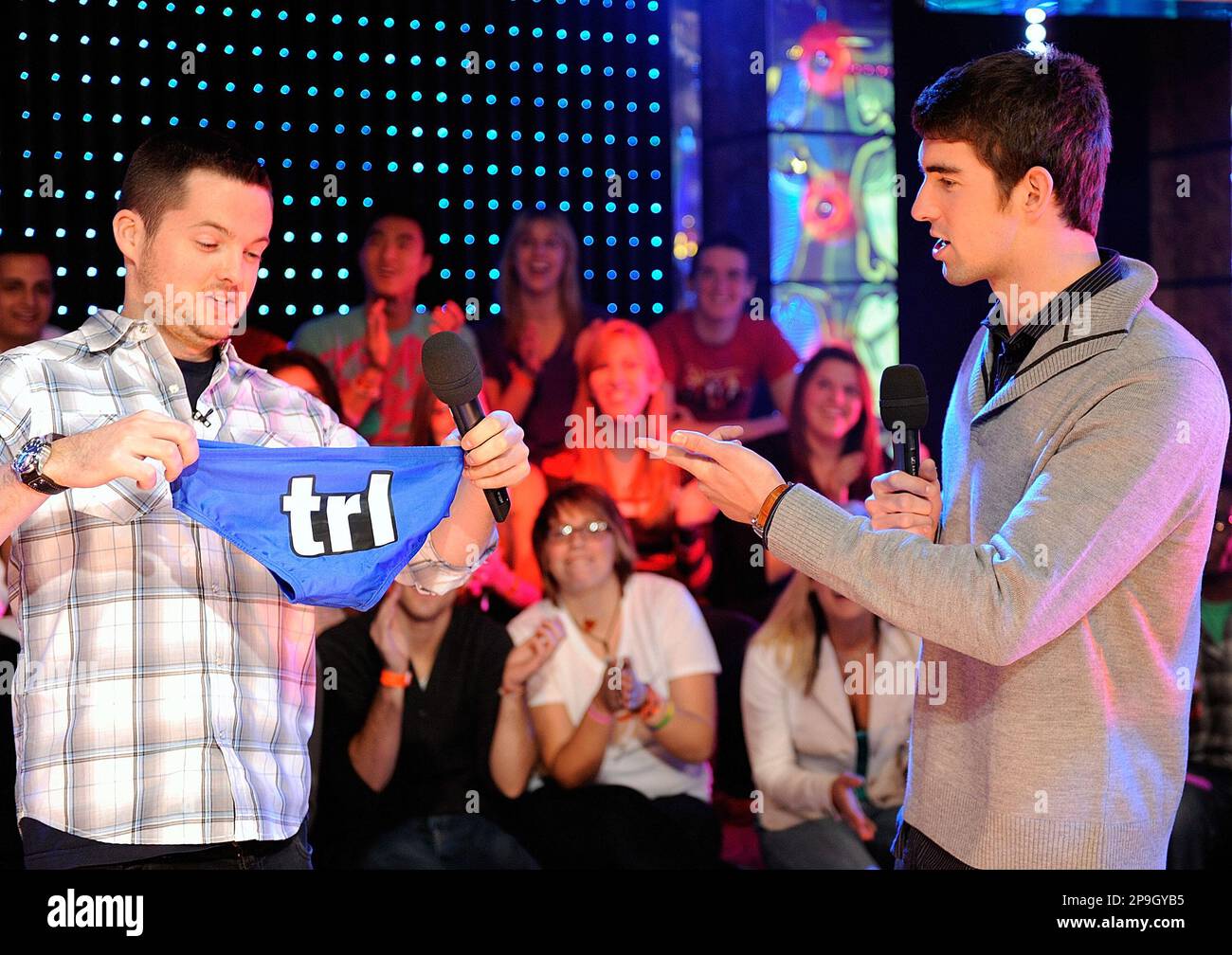 Olympic gold medal swimmer Michael Phelps, right, receives a custom TRL ...