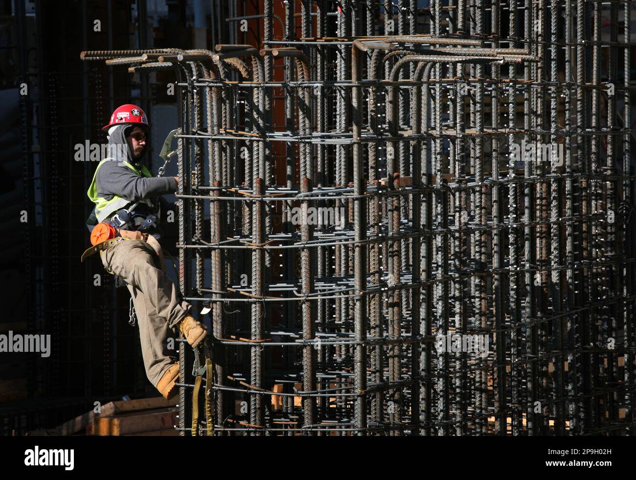 A construction worker ties steel reinforcing bars at the World Trade ...