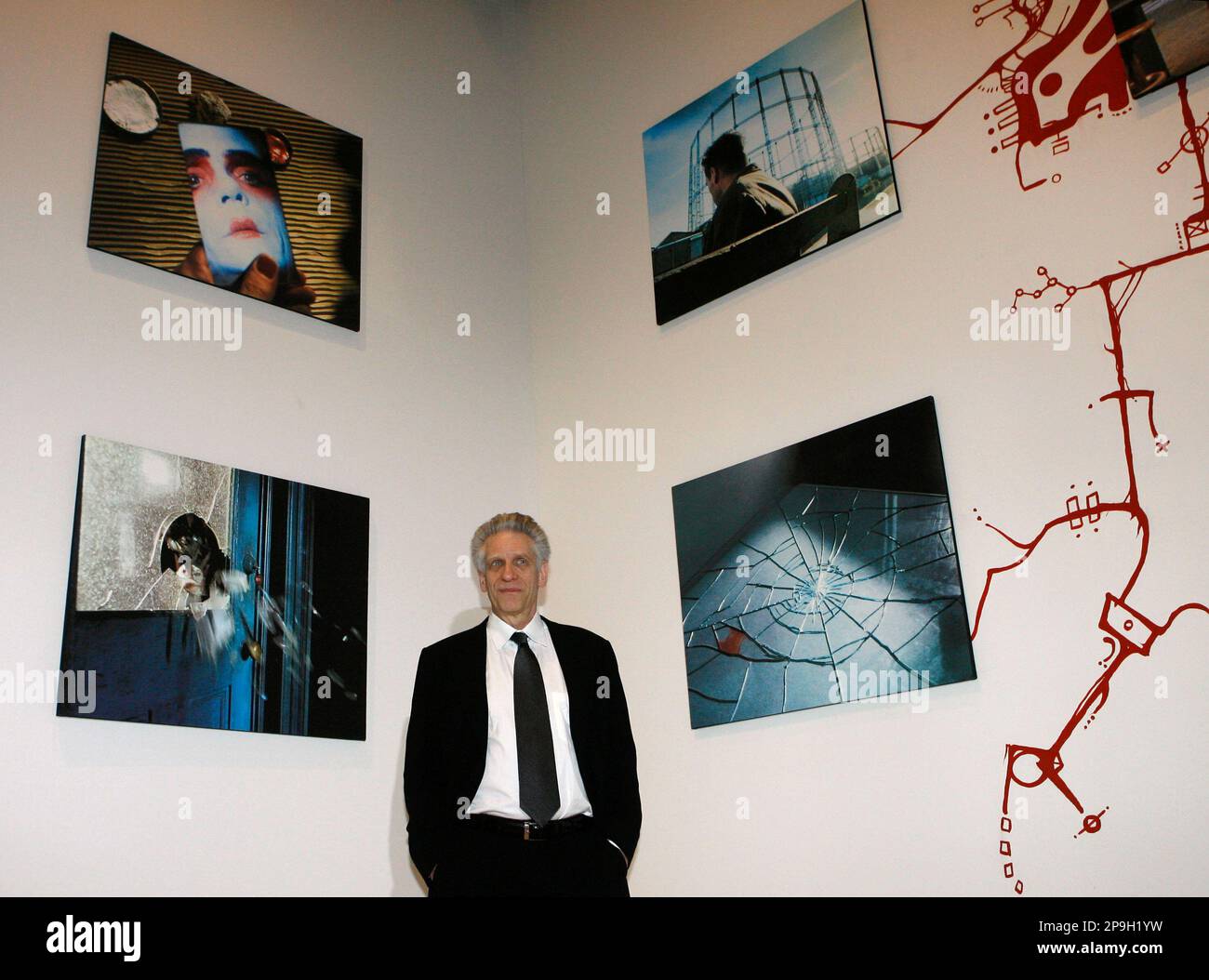 Canadian film director David Cronenberg poses in front of still images ...
