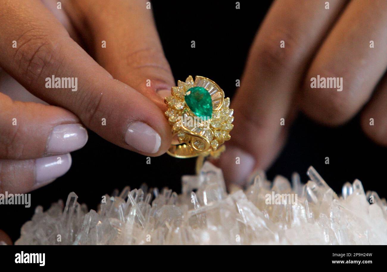 A woman displays a emerald ring at the International Emerald Museum in ...