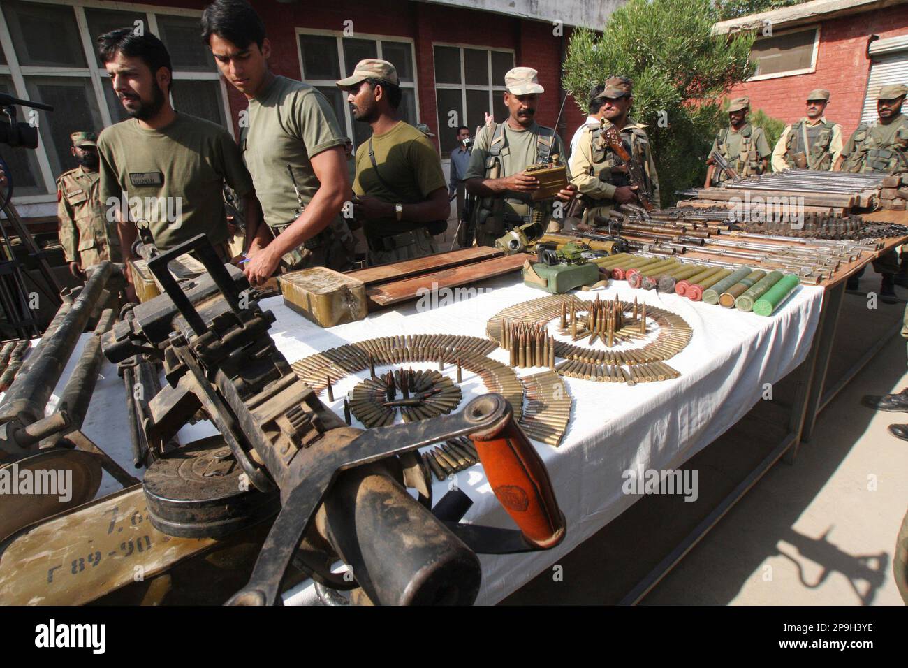 Pakistani soldiers gather around ammunition claimed to be confiscated ...