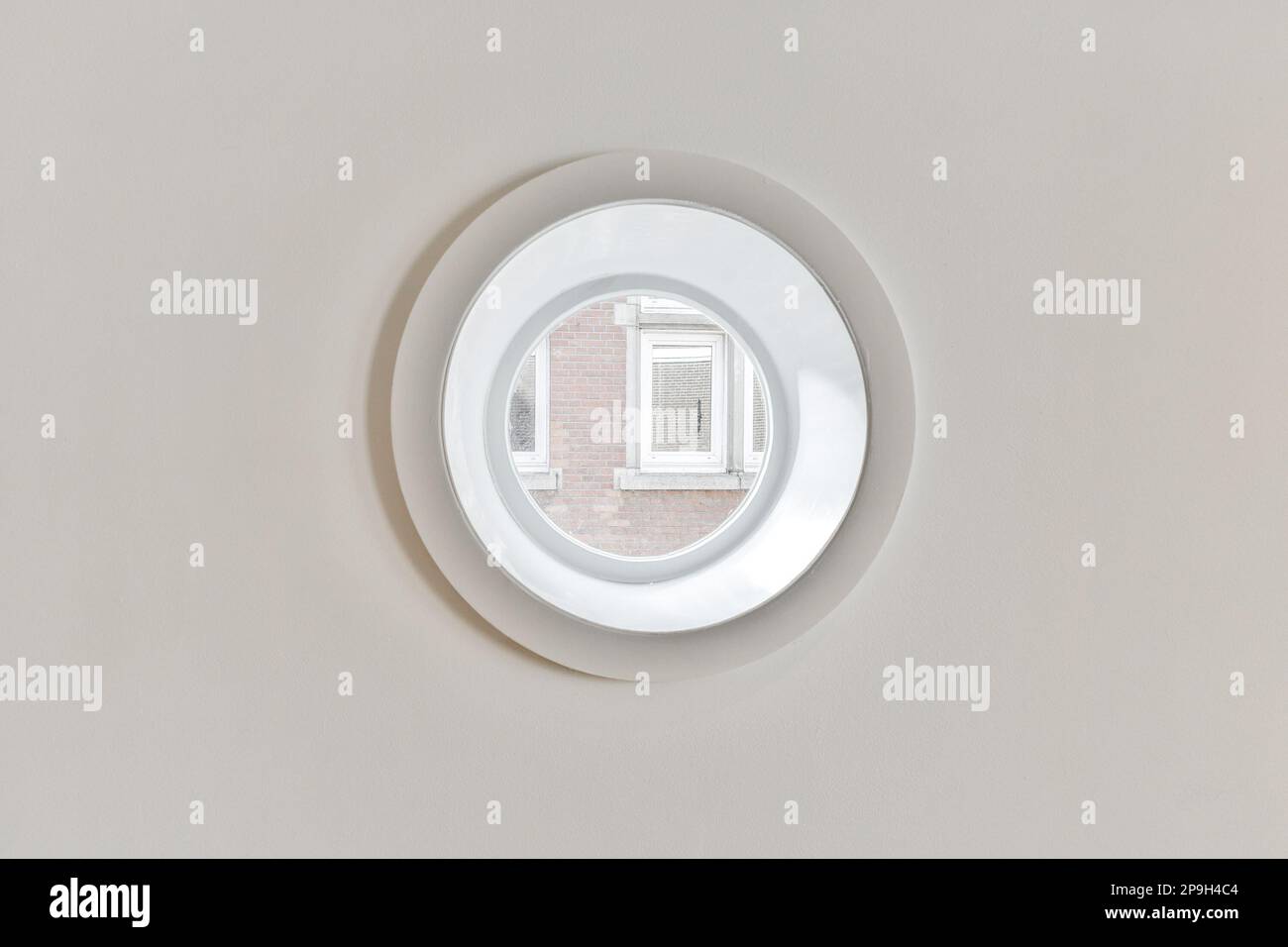 a round window in a wall with a brick pattern on the top and bottom ...