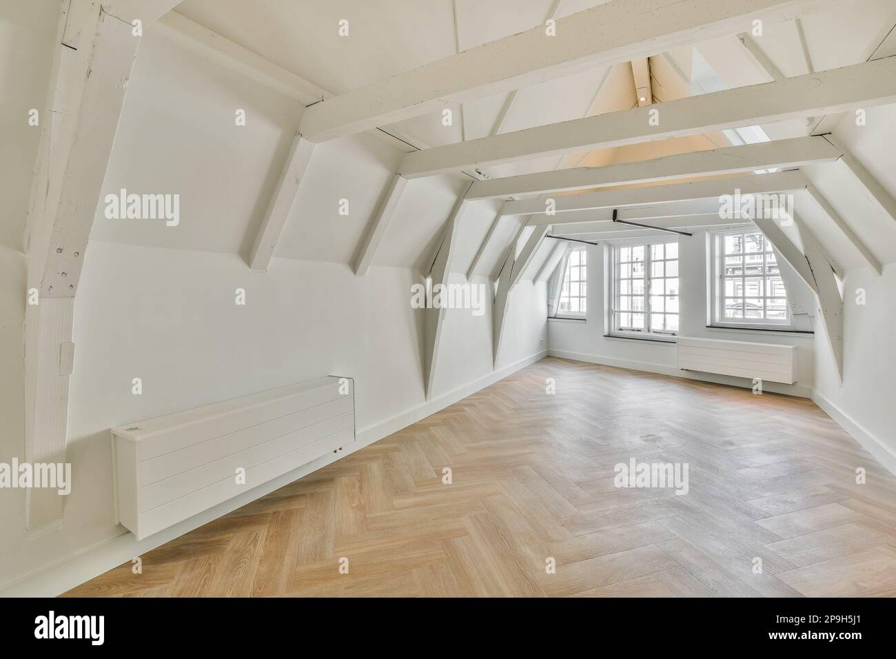 an empty room with white walls and wood flooring in the middle of the ...