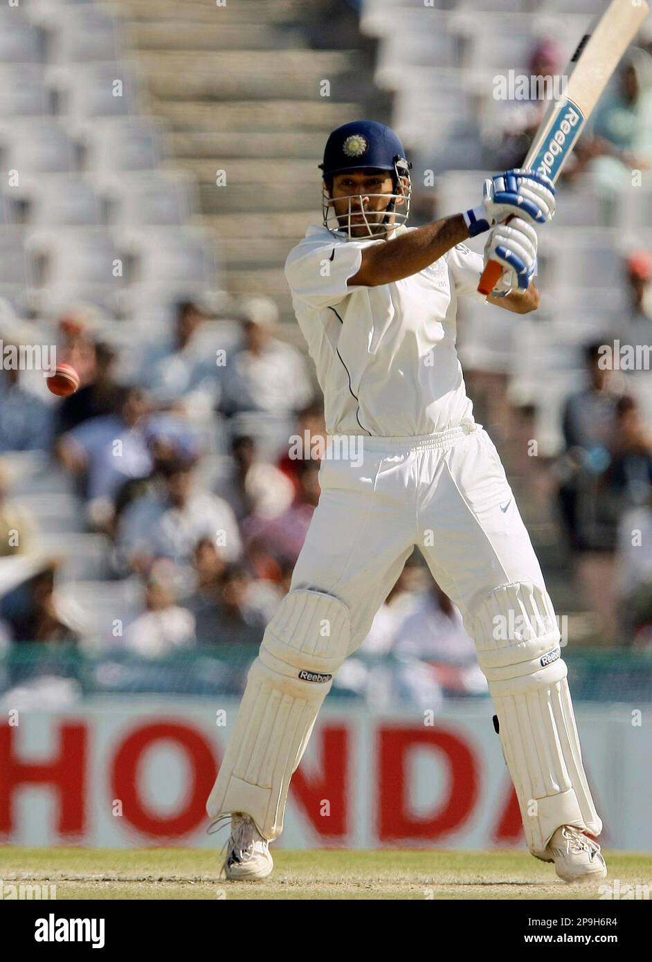 Indian captain Mahendra Singh Dhoni plays a shot on the fourth day of ...