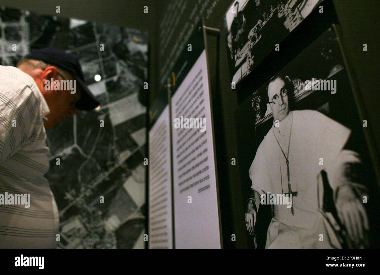 A visitor looks at an exhibit showing wartime Pope Pius XII on display ...