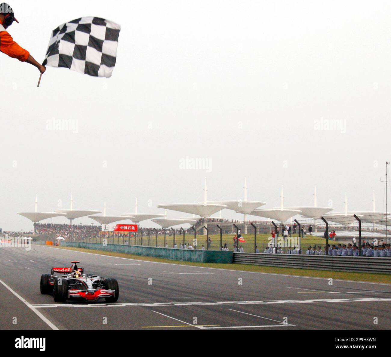 McLaren Mercedes driver Lewis Hamilton of Great Britain crosses the ...
