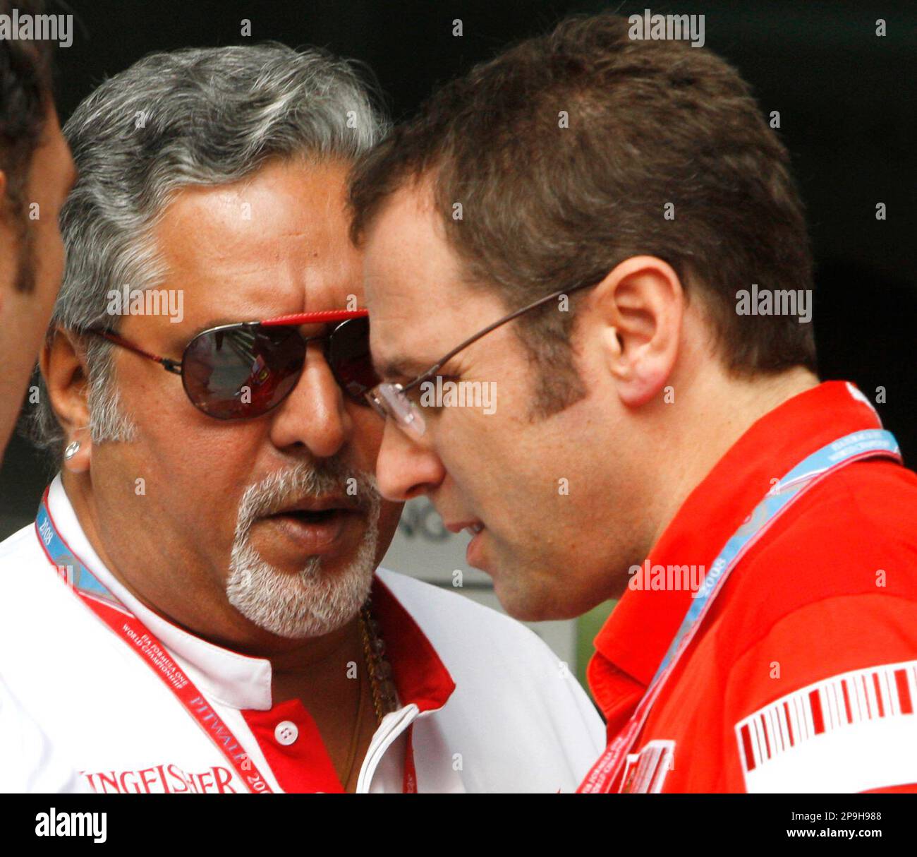 Force India owner Vijay Mallya, left, speaks with Ferrari team ...