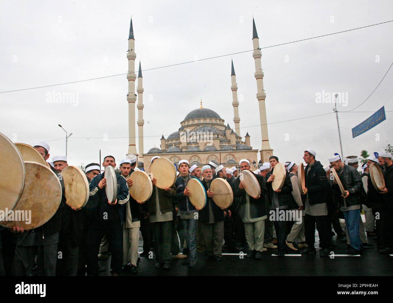 Local Muslims play national instruments during a religious ceremony at ...