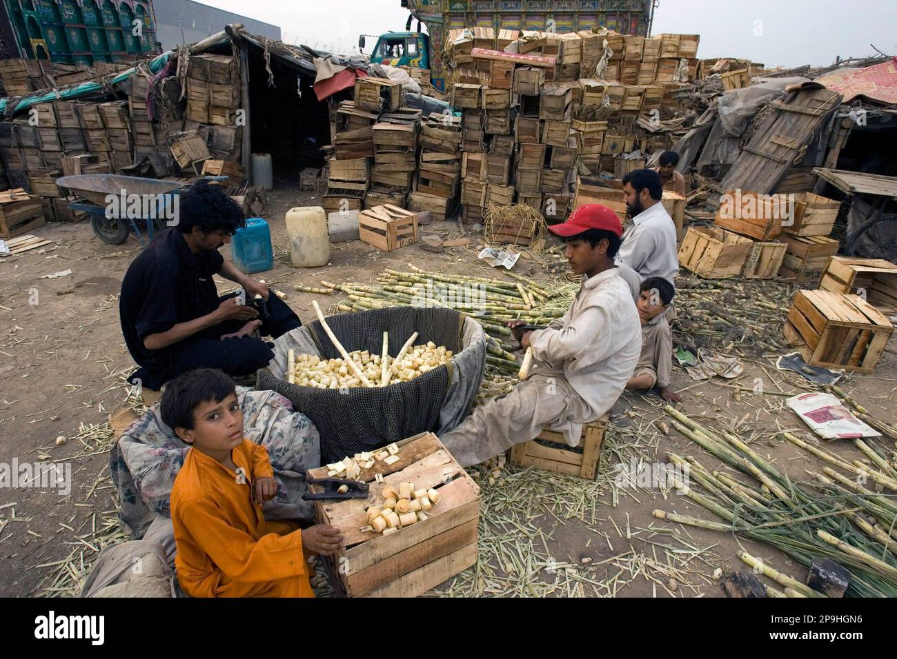A poor Pakistani family living in a make-shift house made of empty ...