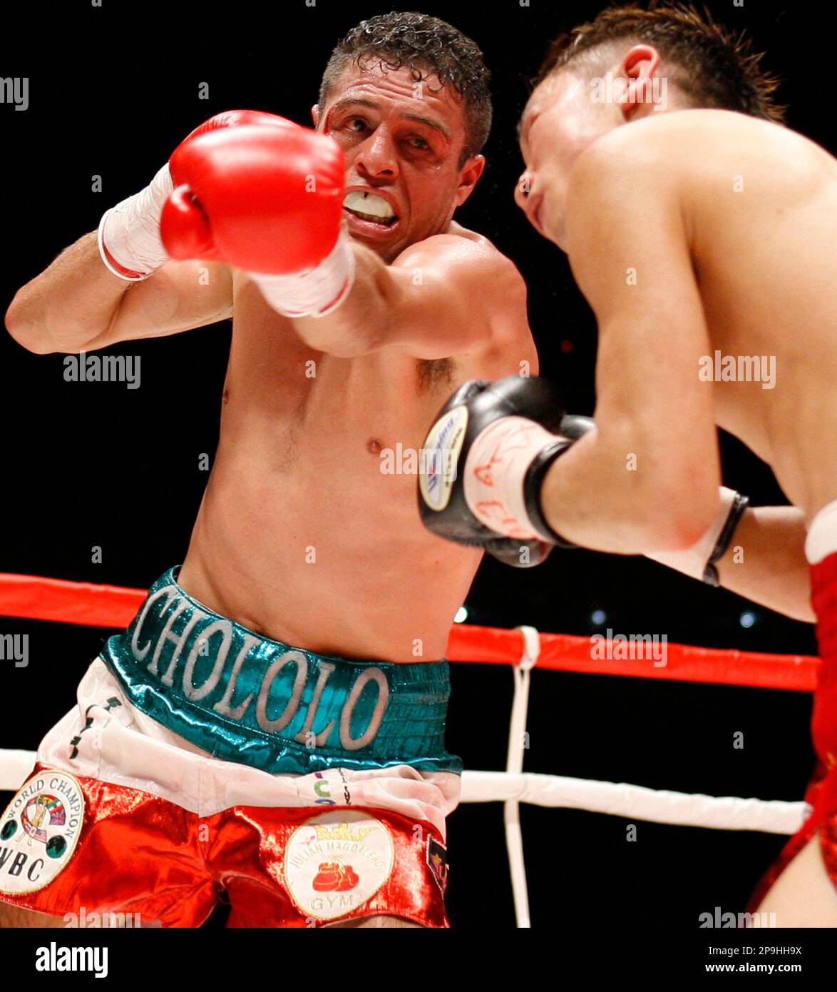 WBC featherweight champion Oscar Larios of Mexico, left, fights ...