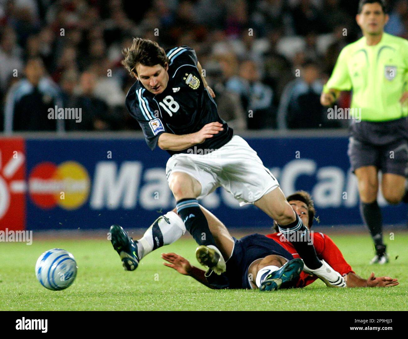 Argentina's Lionel Messi (18) leads the action against Chile's Pablo ...