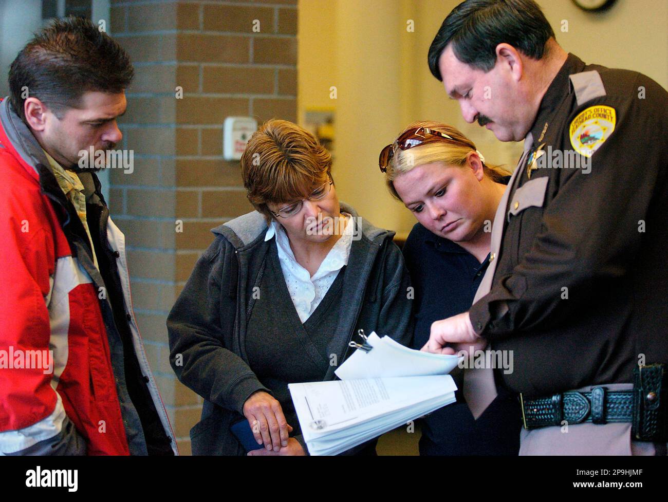 Flathead County Sheriff Mike Meehan shows video still photos to Ginger ...