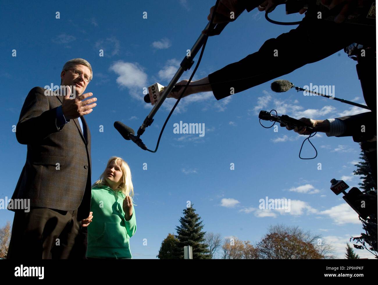 Canadian Prime Minister Stephen Harper talks with reporters with his ...