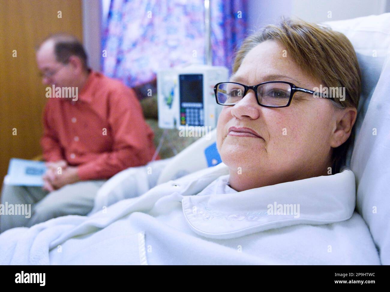 Cynthia Preloh, with her husband Brian Preloh, rests in her hospital ...