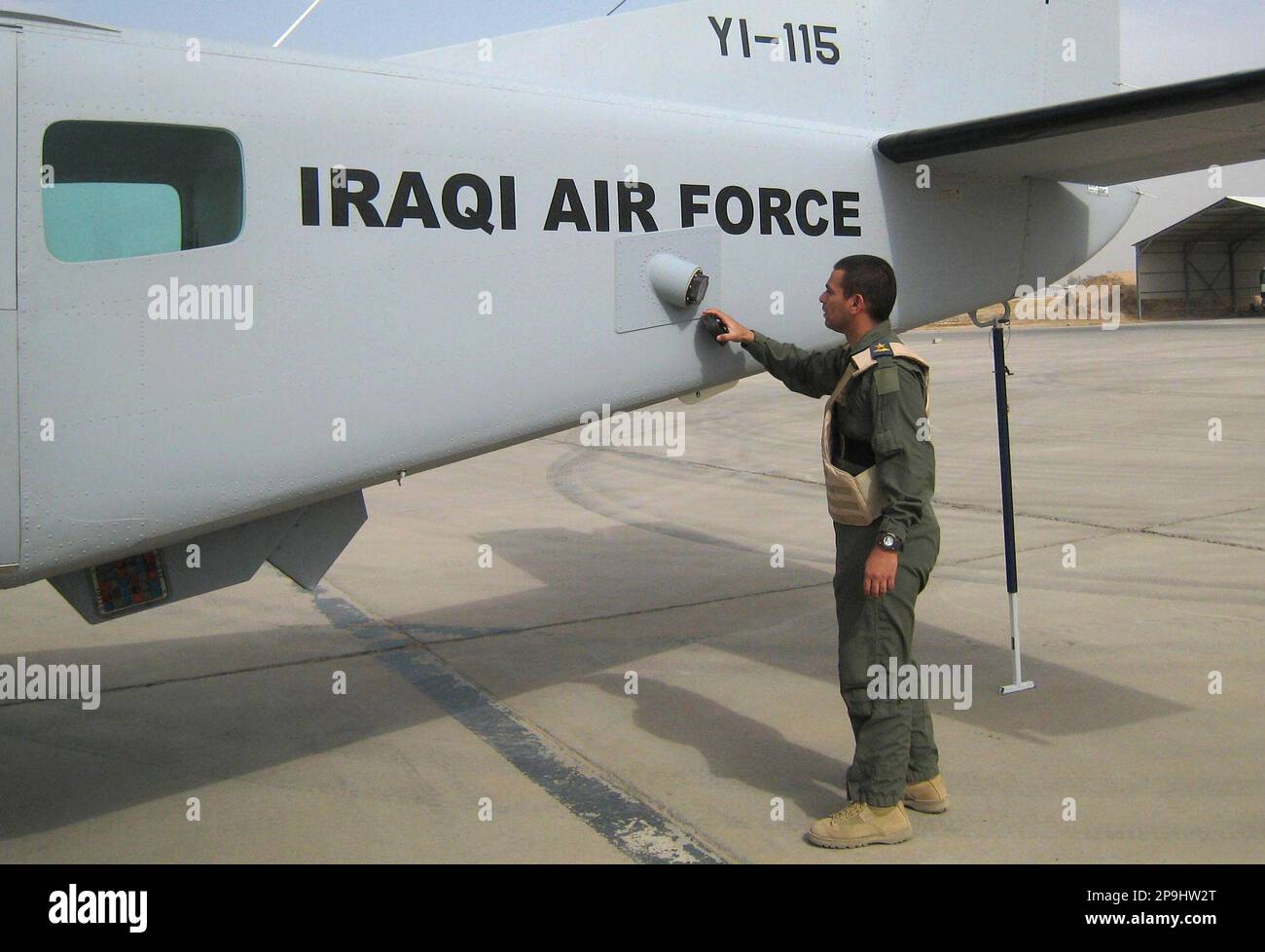 An Iraqi Pilot inspects his aircraft after a graduation ceremony in ...
