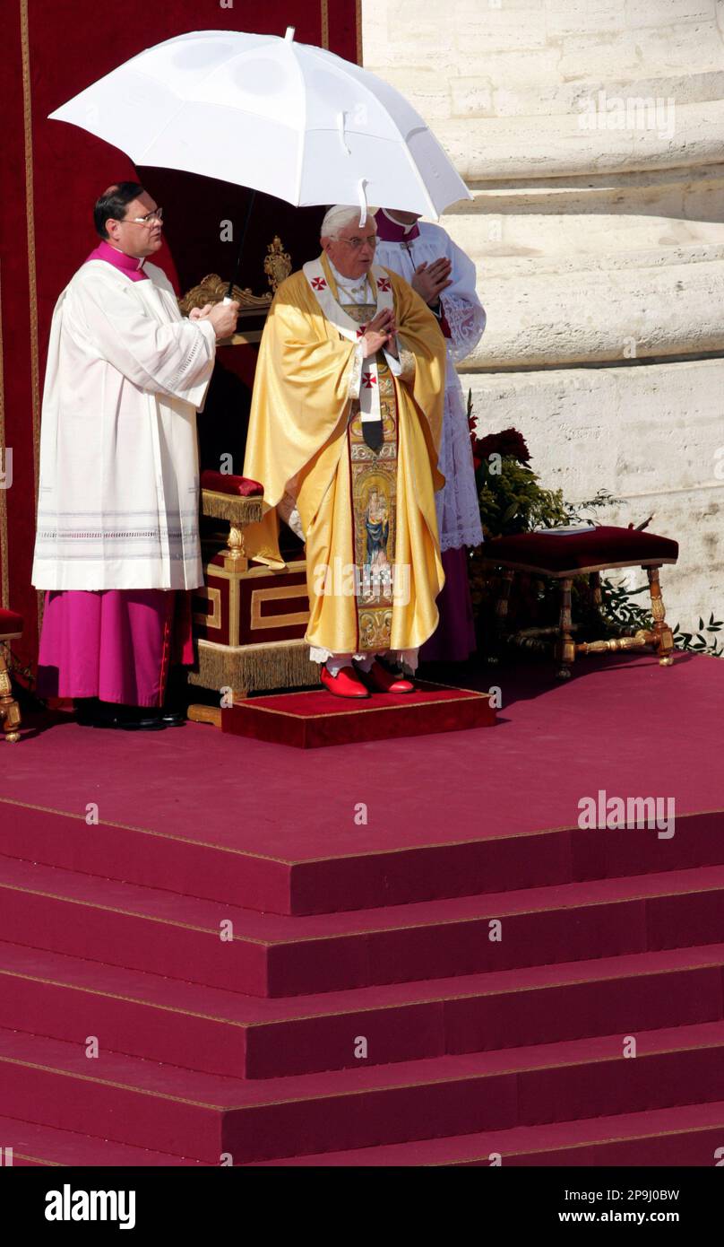 Pope Benedict XVI is sheltered by an umbrella as he celebrates an open ...