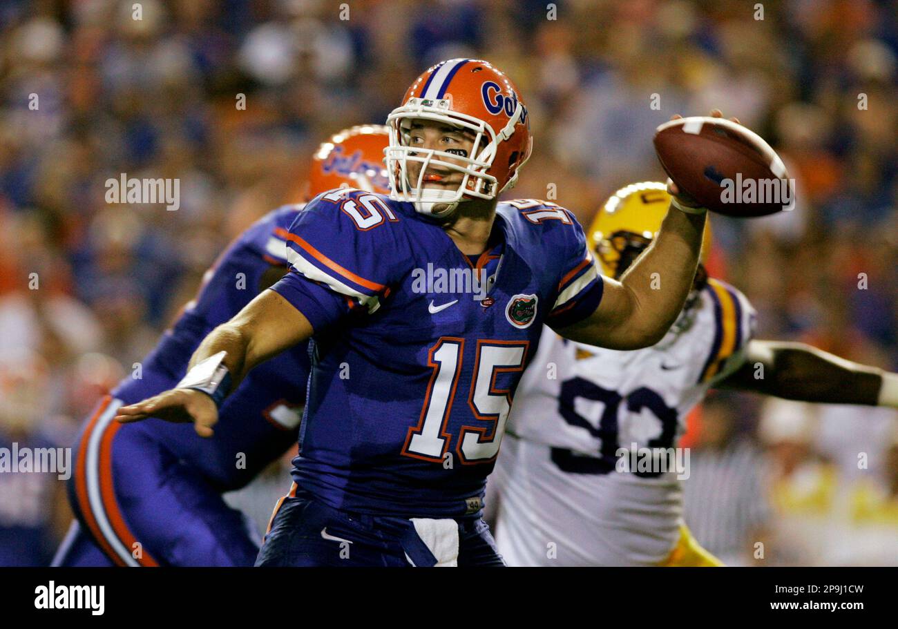 Florida quarterback Tim Tebow (15) throws a pass as he is pressured by ...