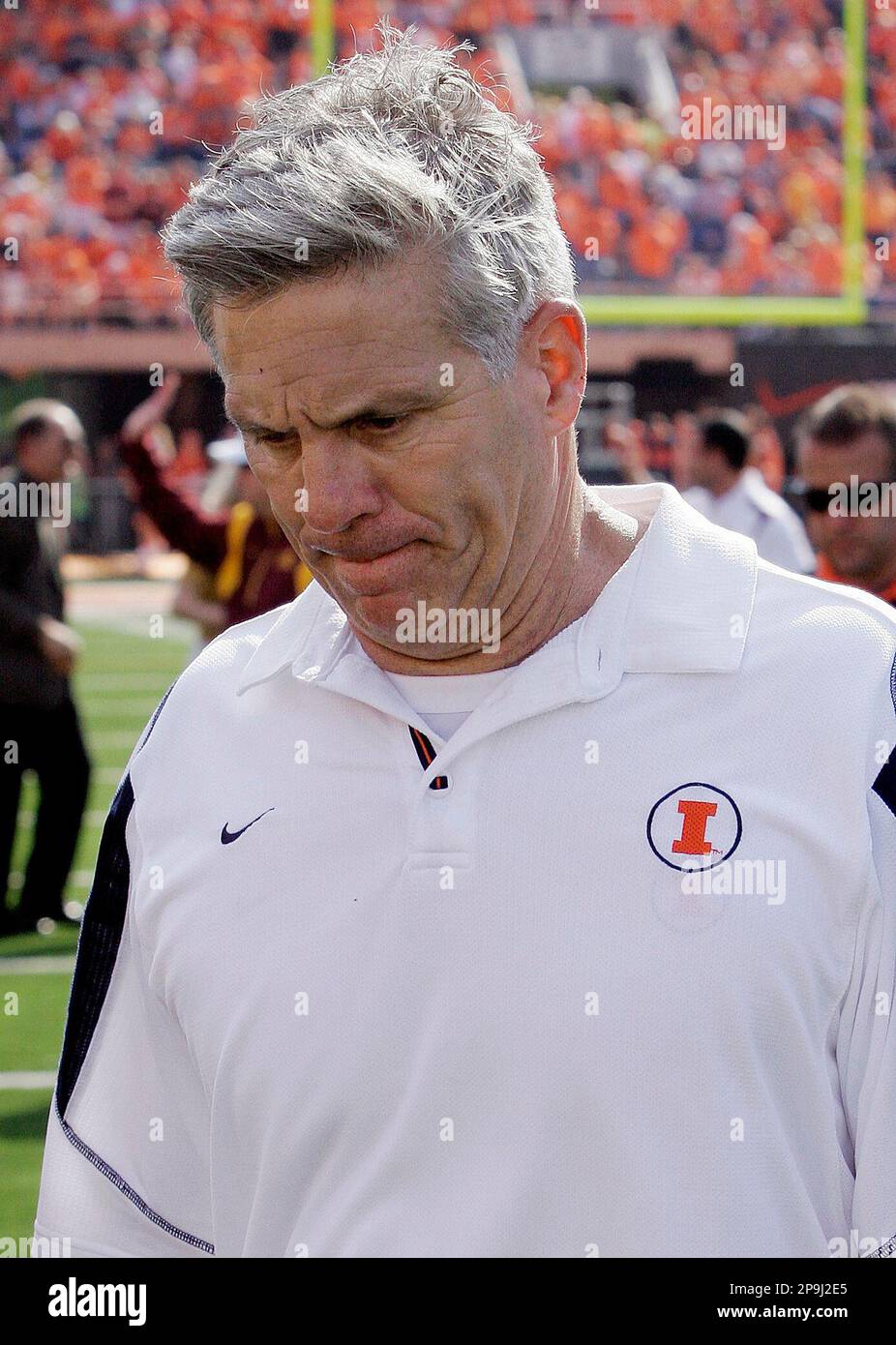 Illinois' Head Coach Ron Zook shows his dejection while walking off the ...