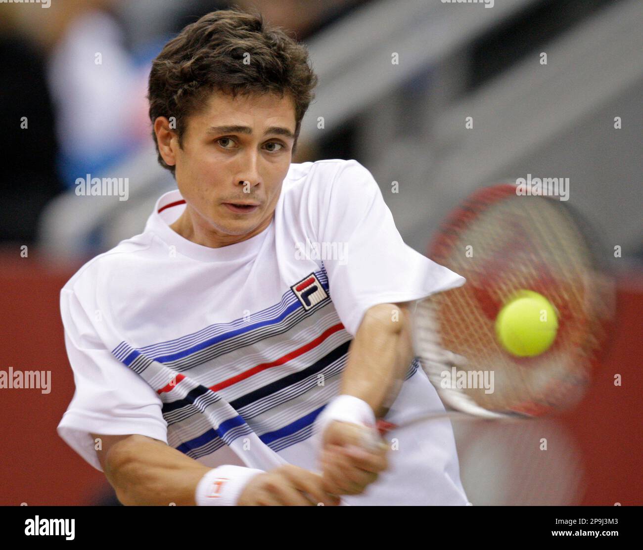Russia's Igor Kunitsyn returns a shot to France's Fabrice Santoro ...