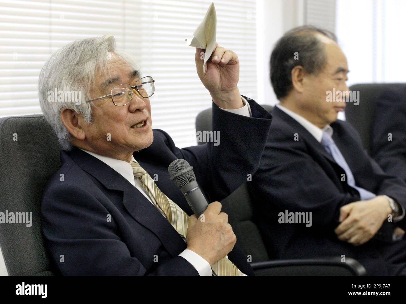 Japanese scientists Toshihide Maskawa, left, and Makoto Kobayashi hold ...