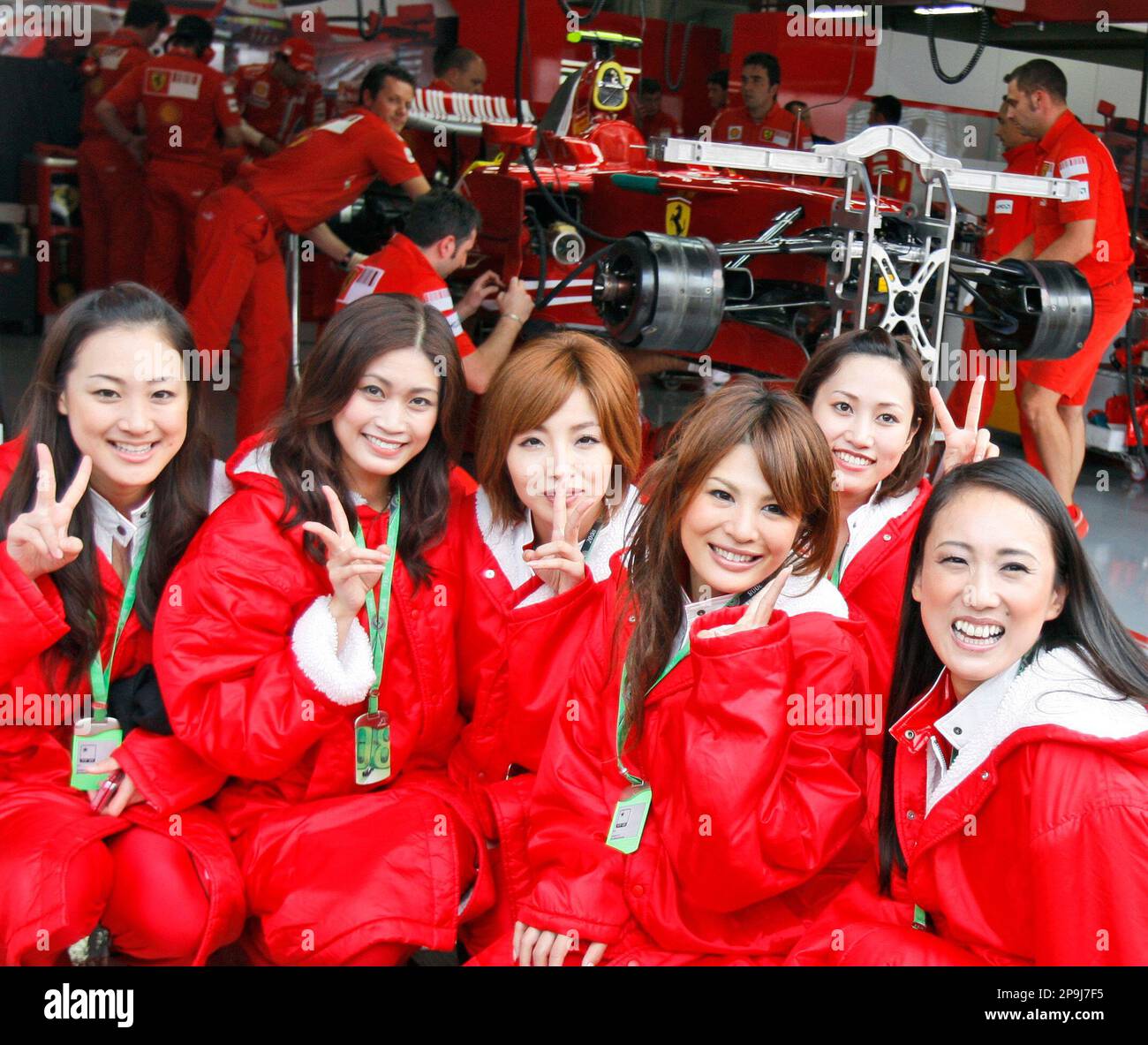 Japanese model pose in front of the Ferrari garage during free practice ...