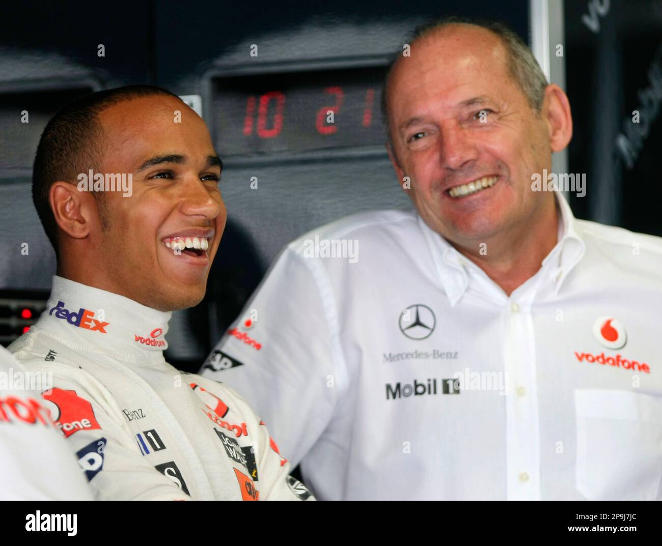 McLaren Formula One driver Lewis Hamilton of Britain, left, smiles with ...