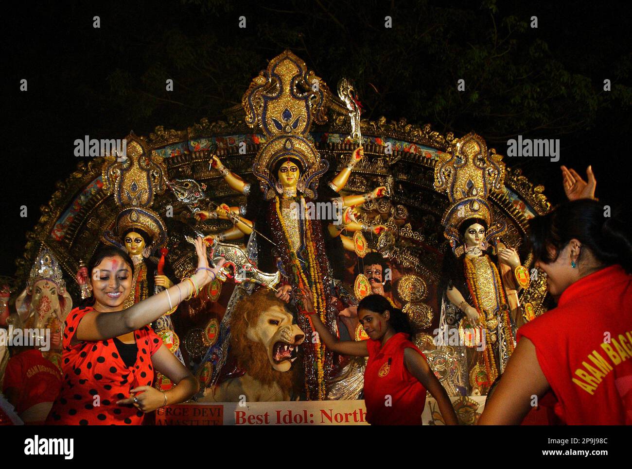 Hindus of the Bengali community dance before an idol of Goddess Durga ...