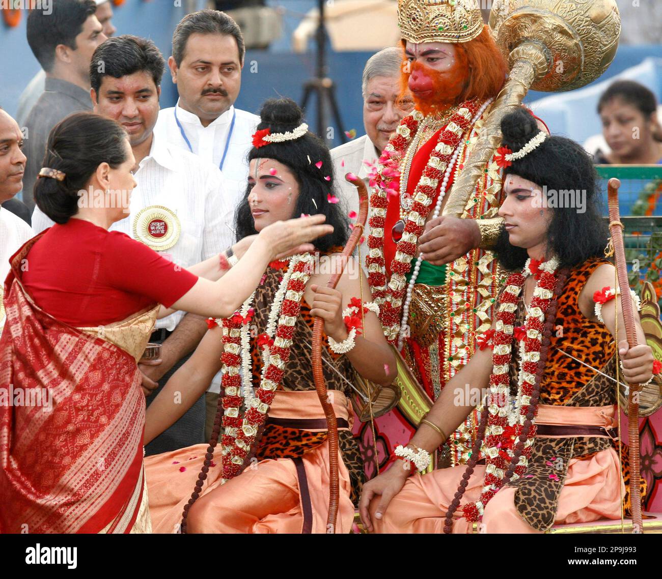 Congress party President Sonia Gandhi throws flower petals on a man ...