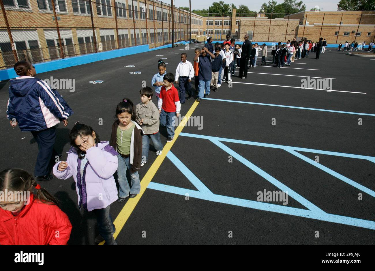 Young students walk behind the Mount Vernon School in Newark, N.J ...