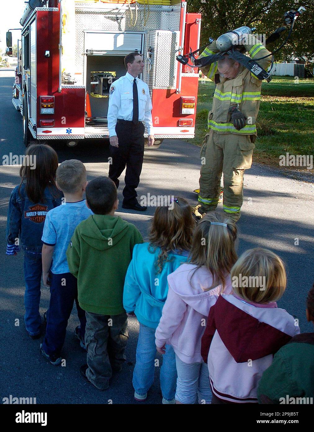 Assistant Fire Chief Dustin Johnson, left, describes what's happening ...