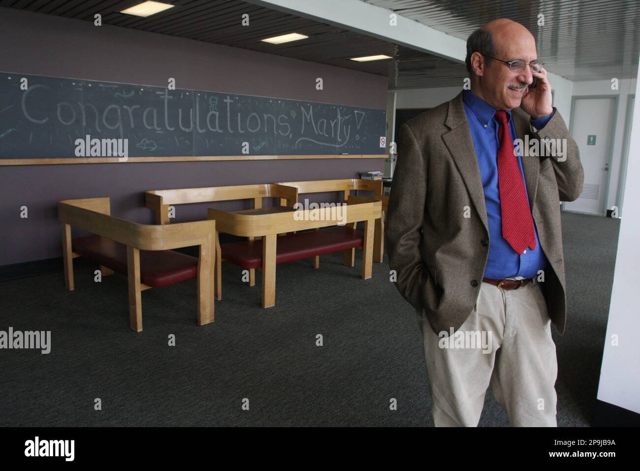 Columbia University professor Martin Chalfie speaks on the phone with ...