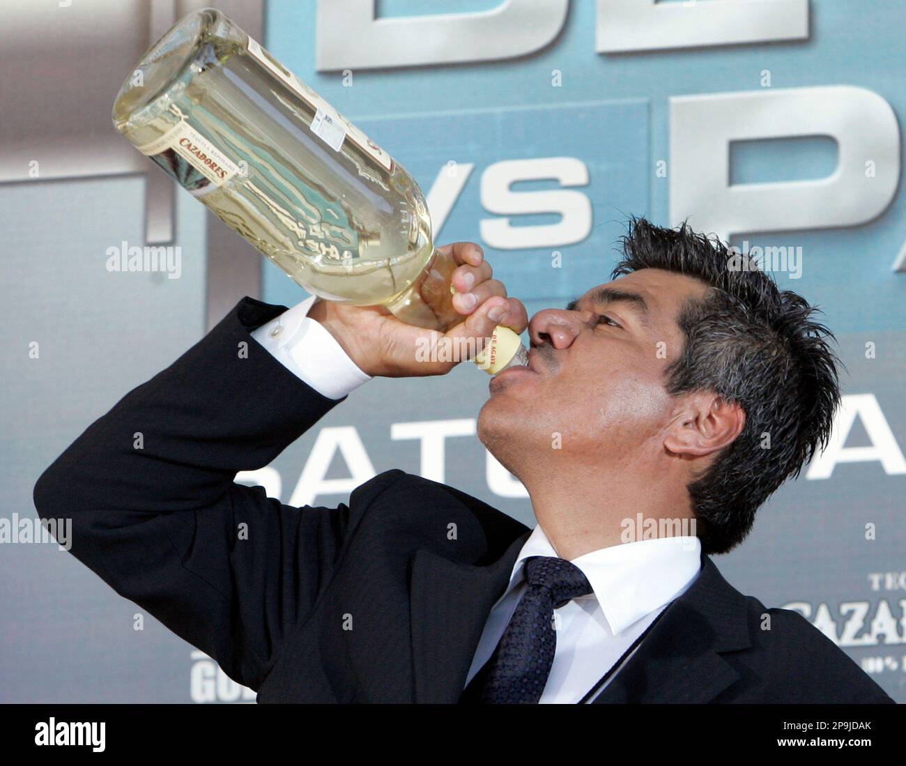 Actor George Lopez, acting as emcee, takes a generous sip of tequila ...