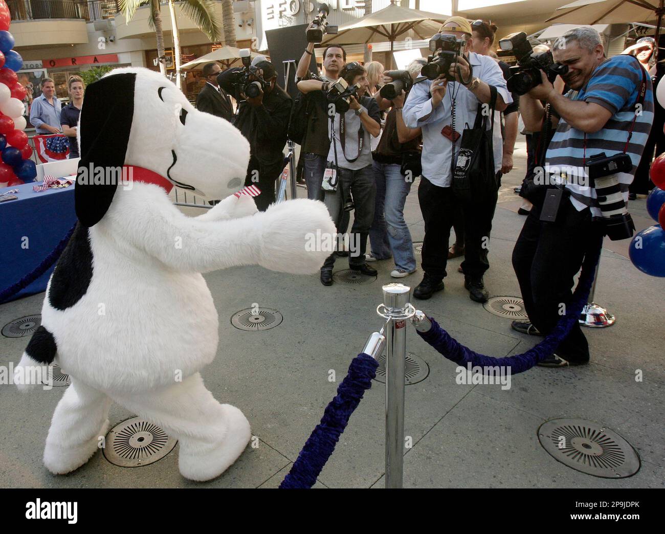 Live Peanuts cartoon characters, including Snoopy, participate in a ...