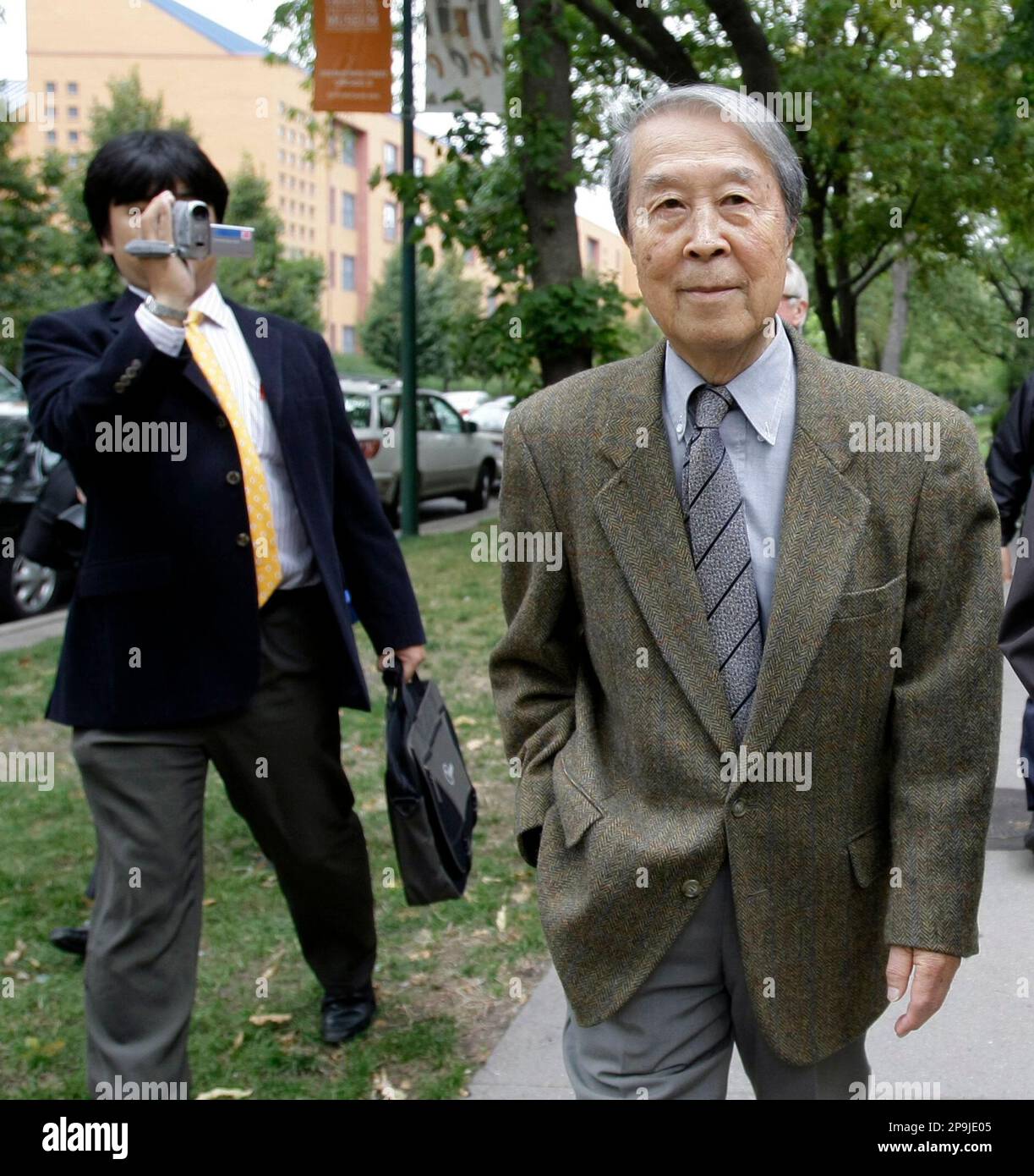 Retired University of Chicago physics professor Yoichiro Nambu walks from his home to a news ...