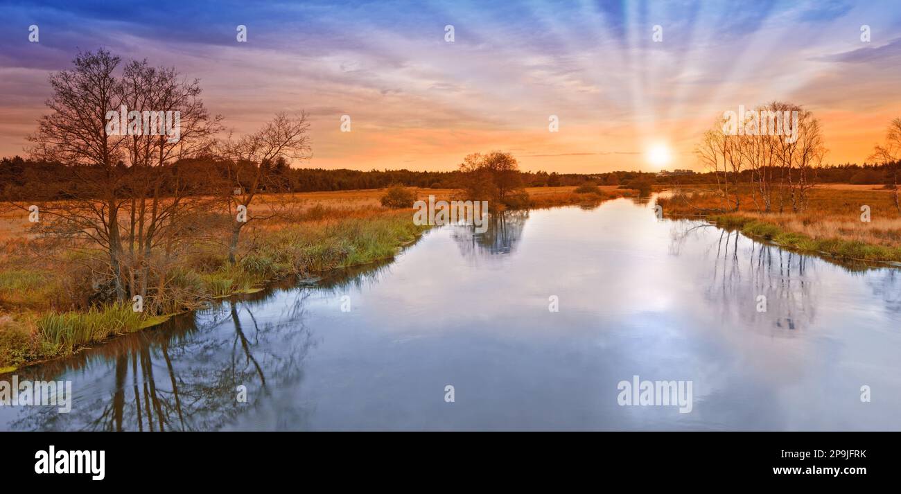 Sunset by a small river. Panoramic sunset shot by a small river Stock ...
