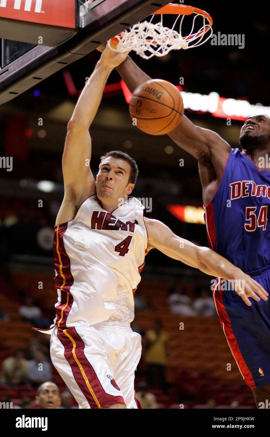 Miami Heat's David Padgett, left, dunks against Detroit Pistons' Jason ...