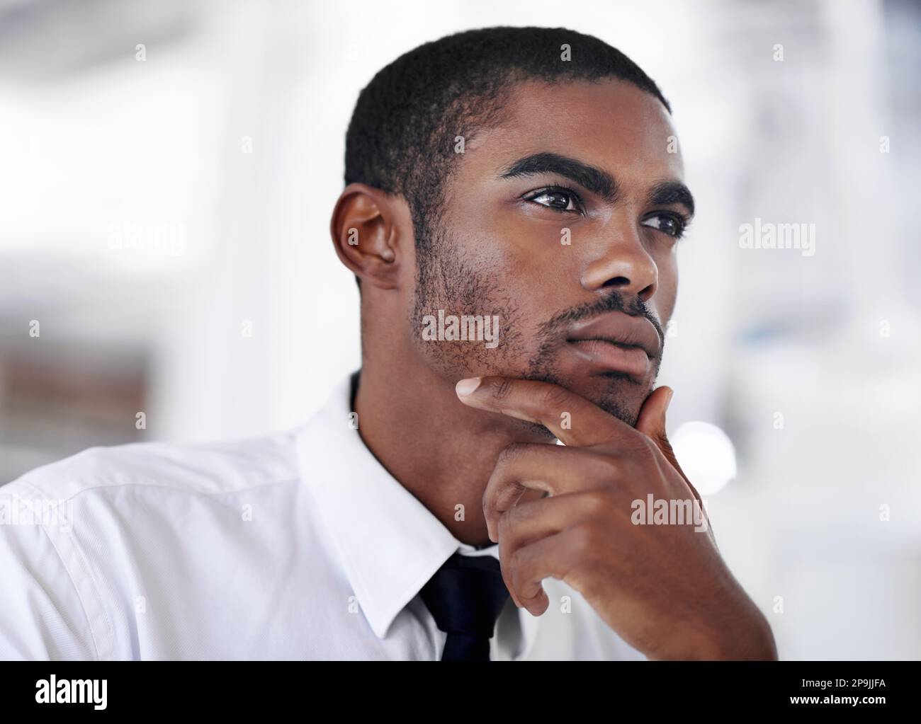 Mulling over the next step of his corporate journey. a young ...