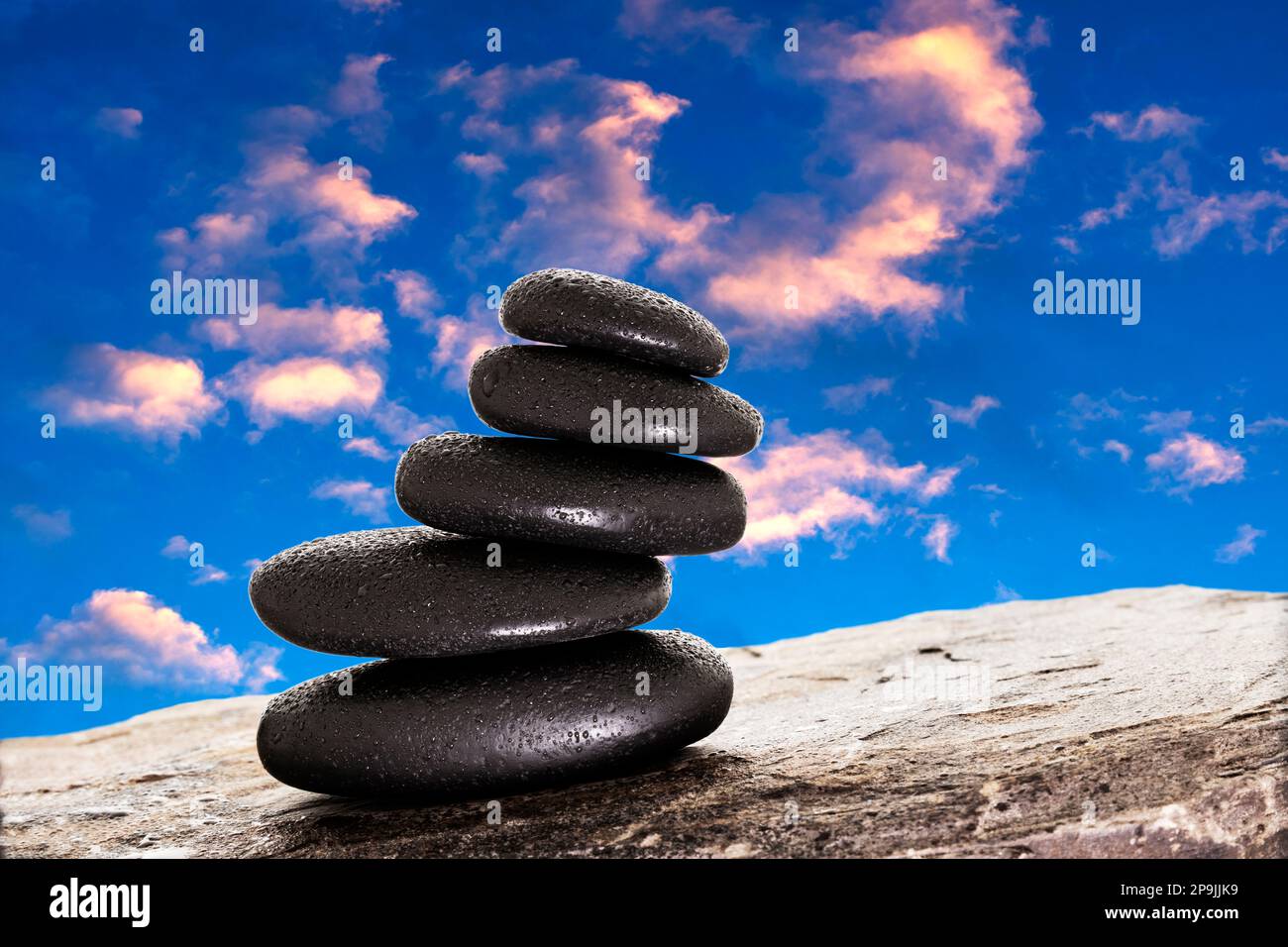 Wellness stones in front of sky Stock Photo - Alamy