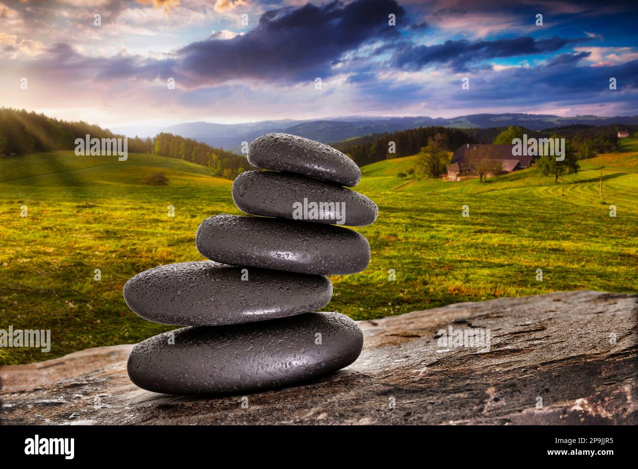 Wellness stones in front of landscape Stock Photo - Alamy