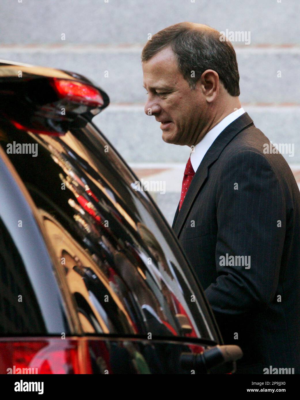 Chief Justice John Roberts walks to his motorcade after attending ...