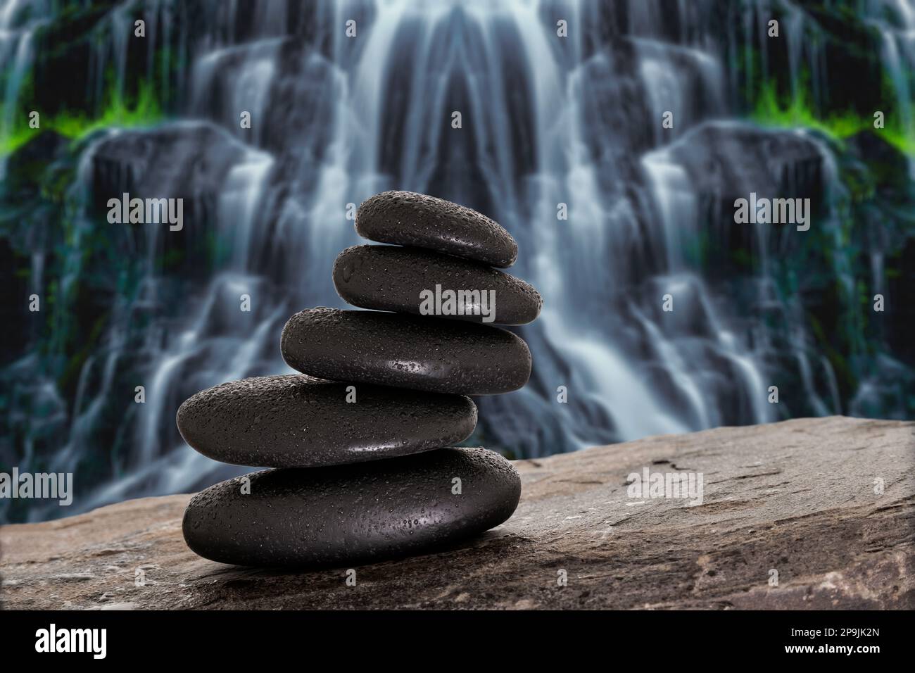 Massage stones on stone underground in front of a waterfall Stock Photo ...