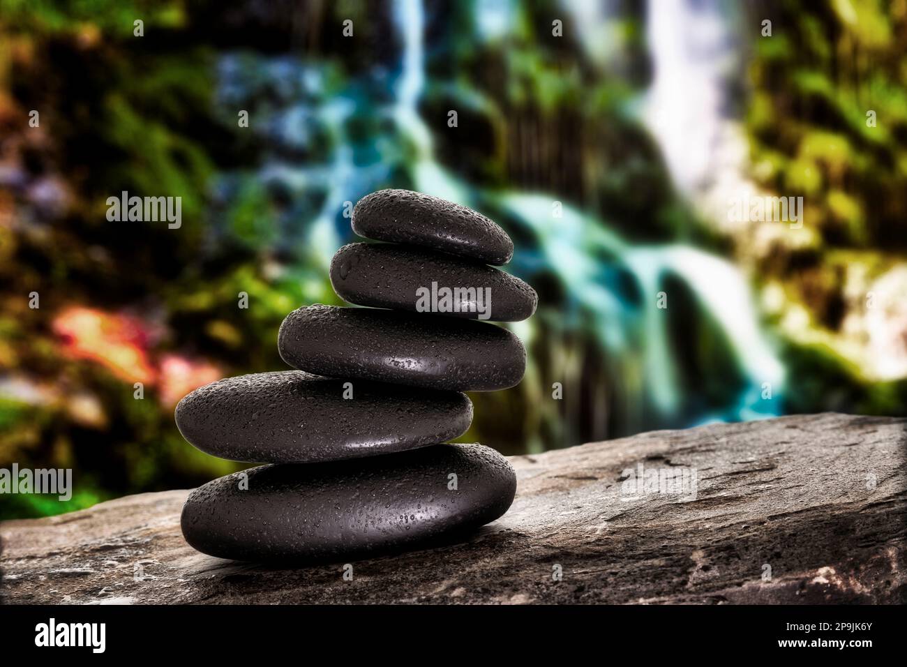 Massage stones on stone underground in front of a waterfall Stock Photo ...