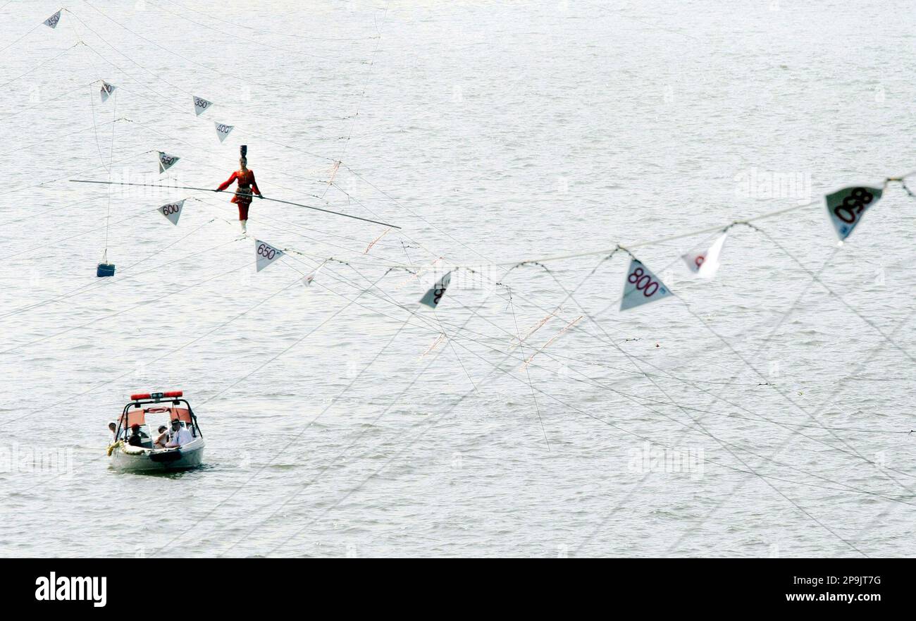 Chinese woman Aixiguli walks a high wire during the World High Wire ...