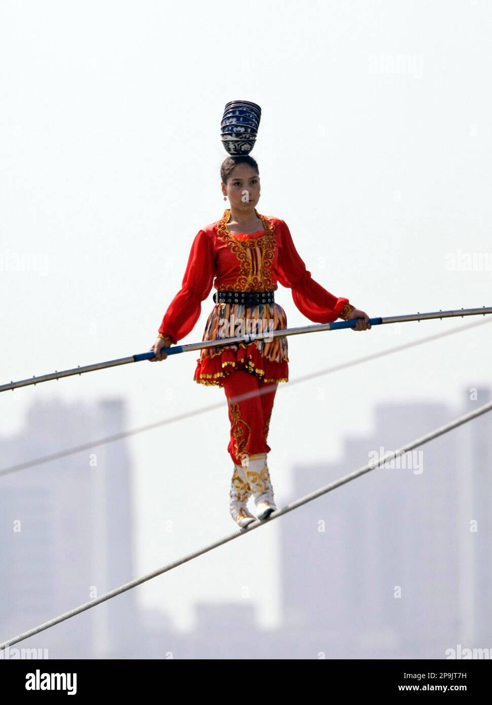 Chinese woman Aixiguli walks a high wire during the World High Wire ...
