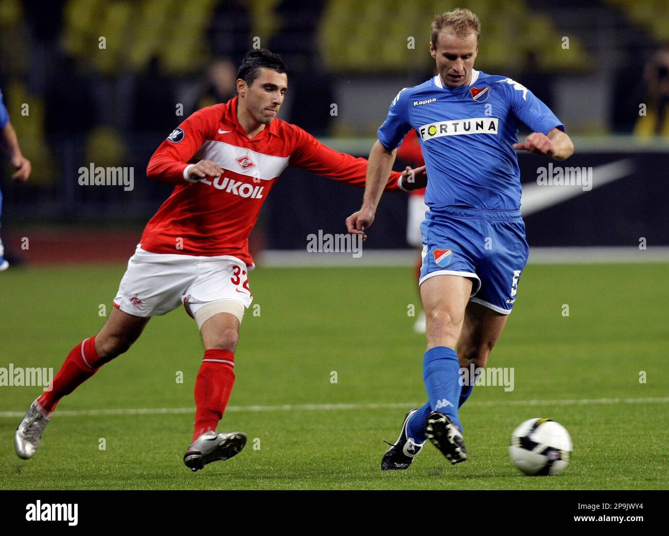 Spartak Moscow's Nikita Bazhenov, left, fight for the ball with FC ...