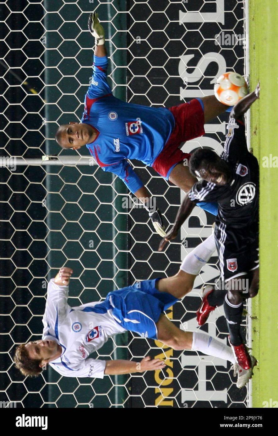 Cruz Azul goalkeeper Alfonso Blanco, background right, watches the ball ...
